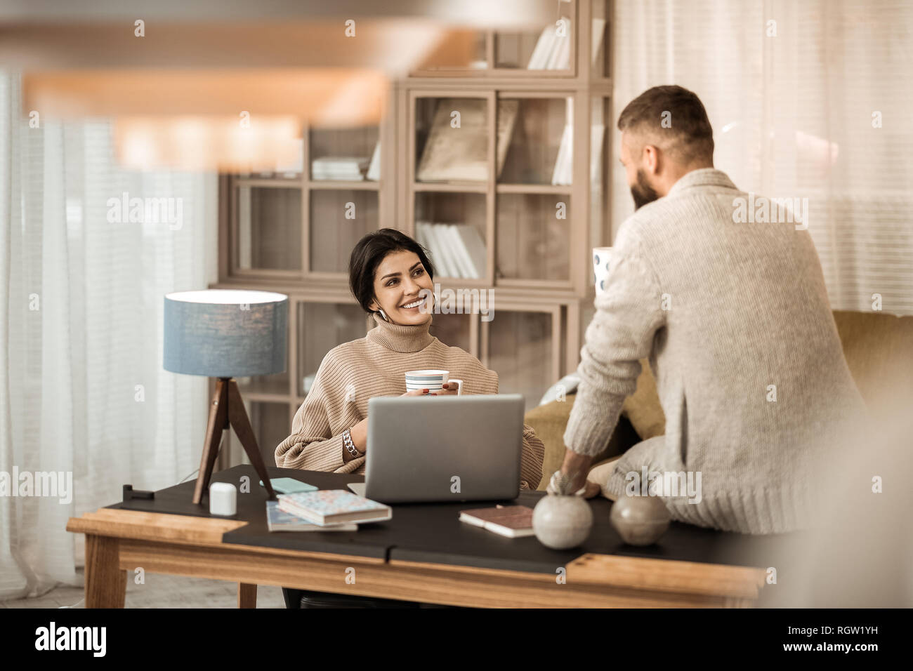 Appealing positive couple having conversation together while sitting in ...