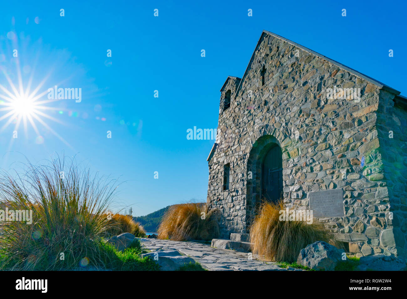 Iconic stone church Church of Good Shepherd with sun flare illuminating ...