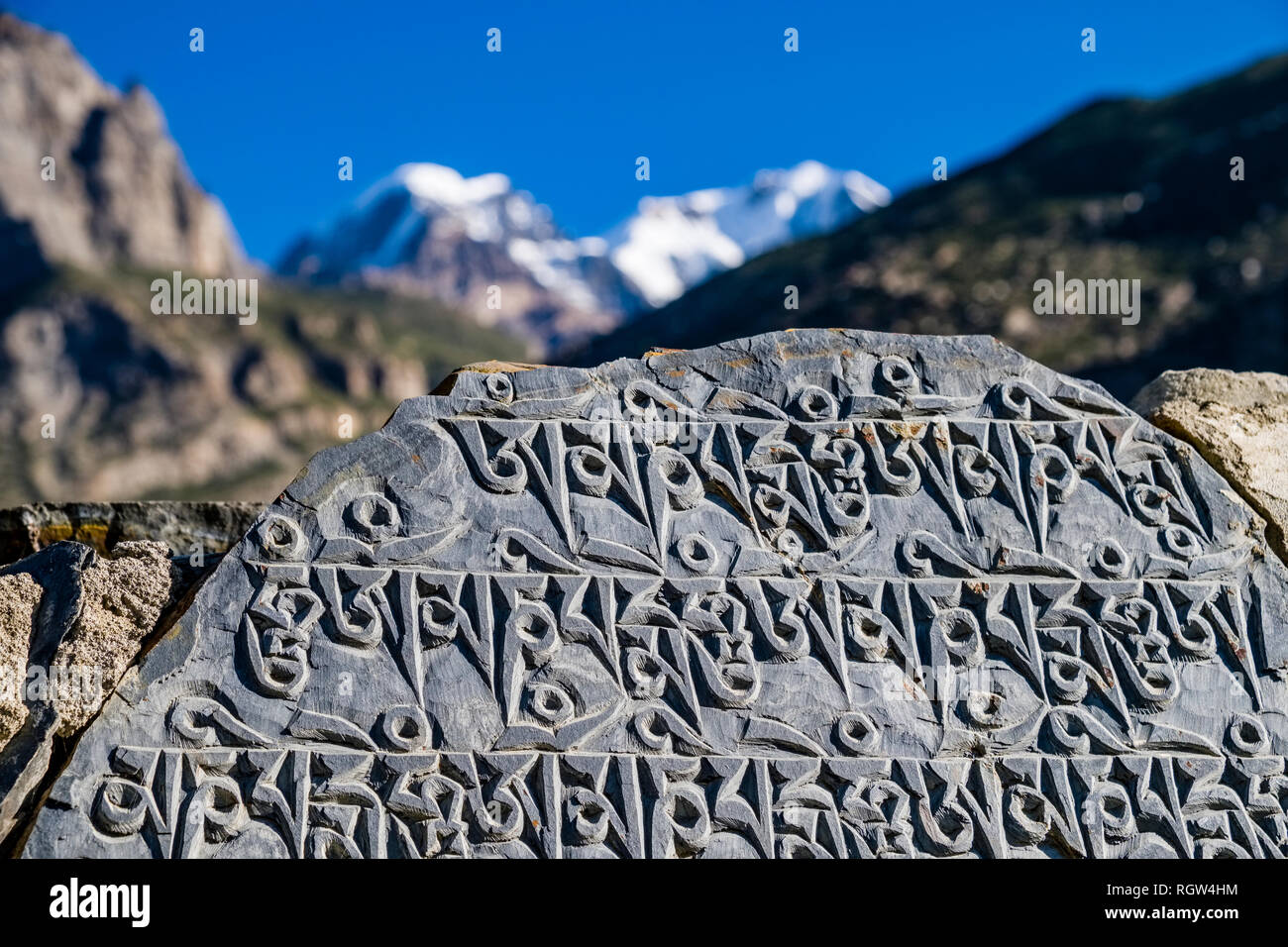 Mani Stone with the rock carved buddhist mantra of Avalokiteshwara, the ...