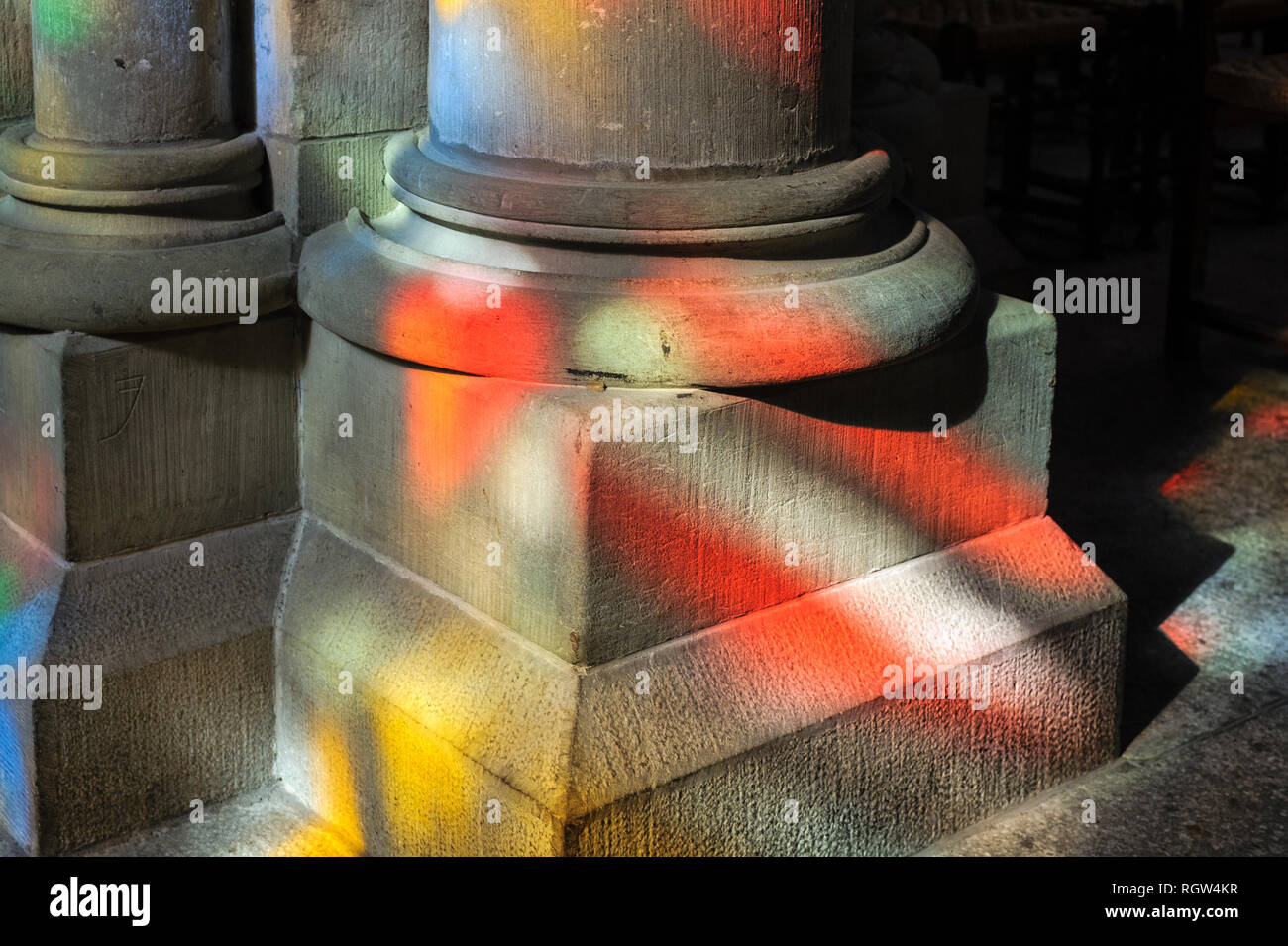Sunlight through stained glass on pillars of a church Stock Photo - Alamy