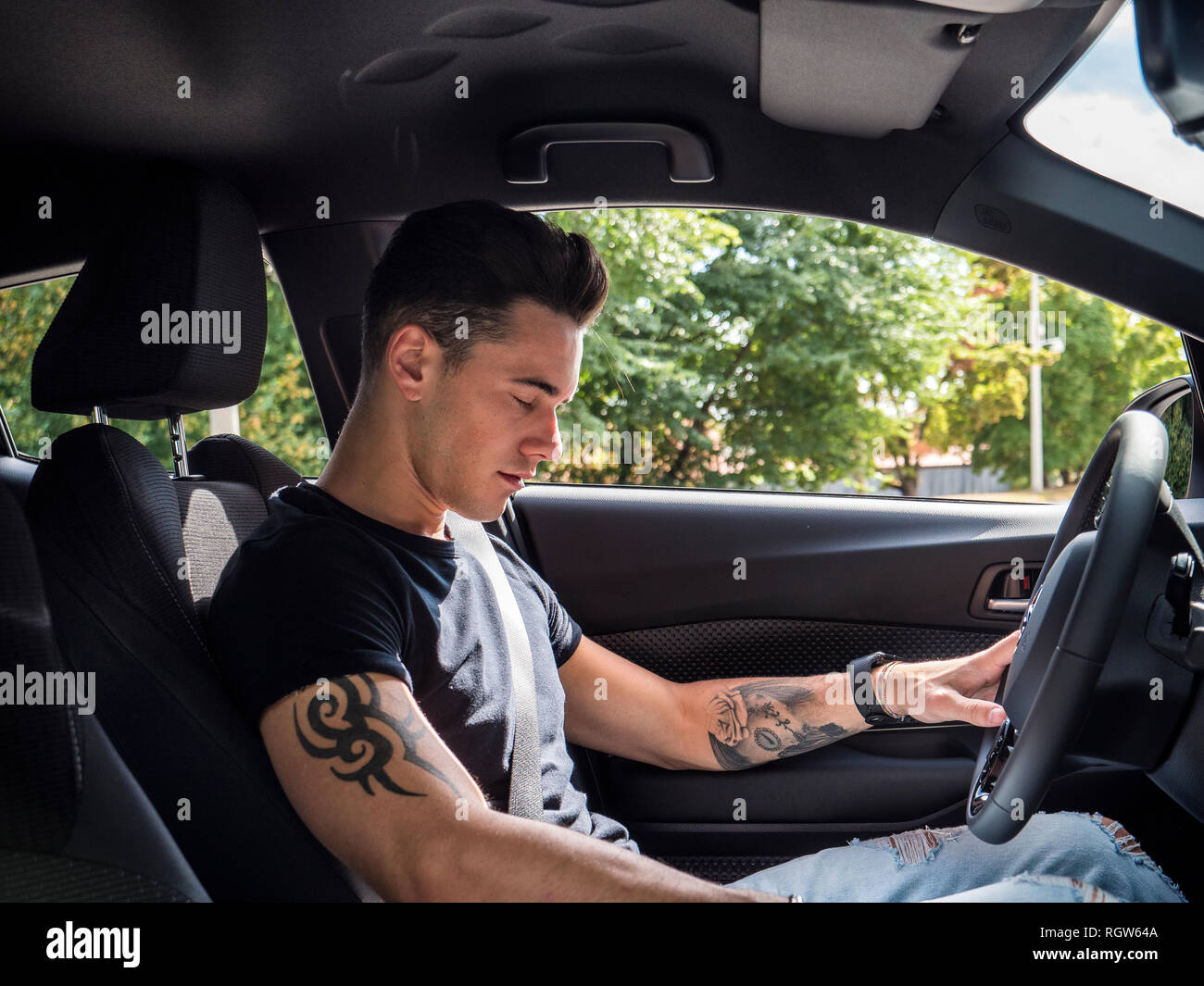Handsome Young Man falling asleep while driving a Car, resting at wheel ...
