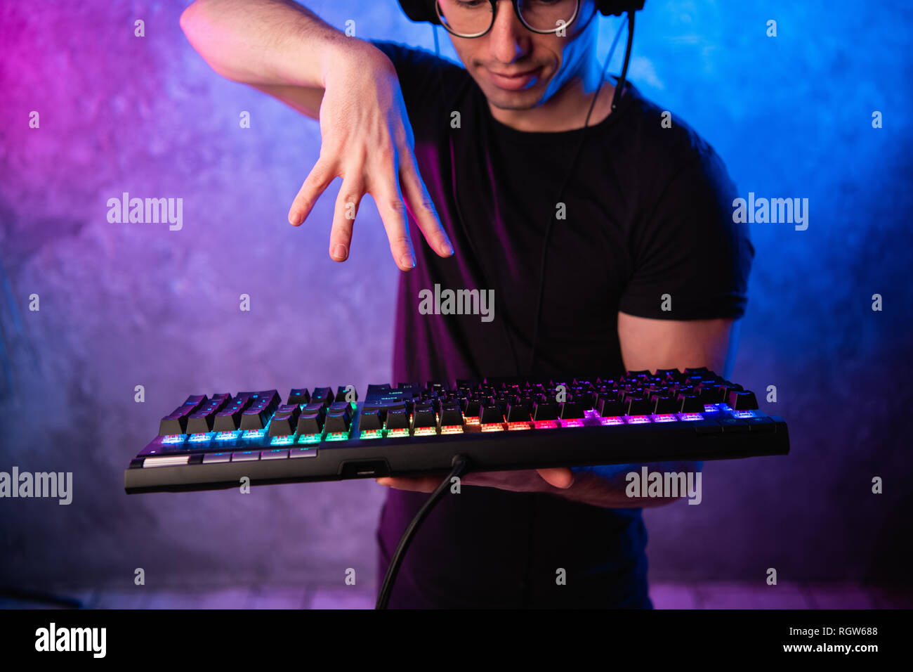 Close-up on gamer's hands going to press a key on a keyboard ...