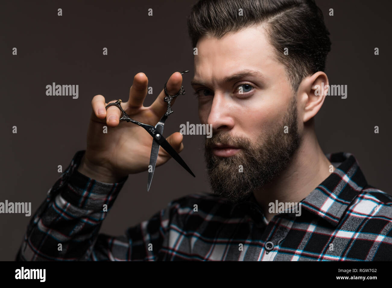 Bearded brunette barber holding hi-res stock photography and images - Alamy