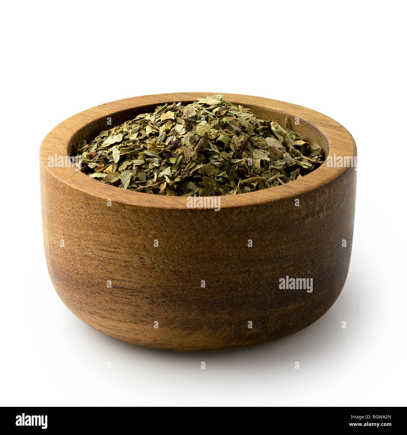 Dried chopped basil in a dark wood bowl isolated on white Stock Photo ...