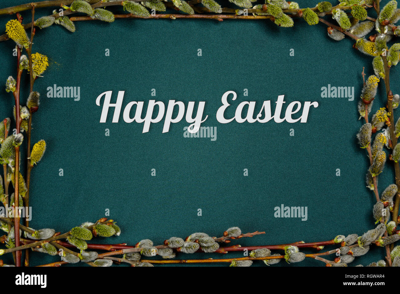 The inscription "Easter" on a green background surrounded by branches ...