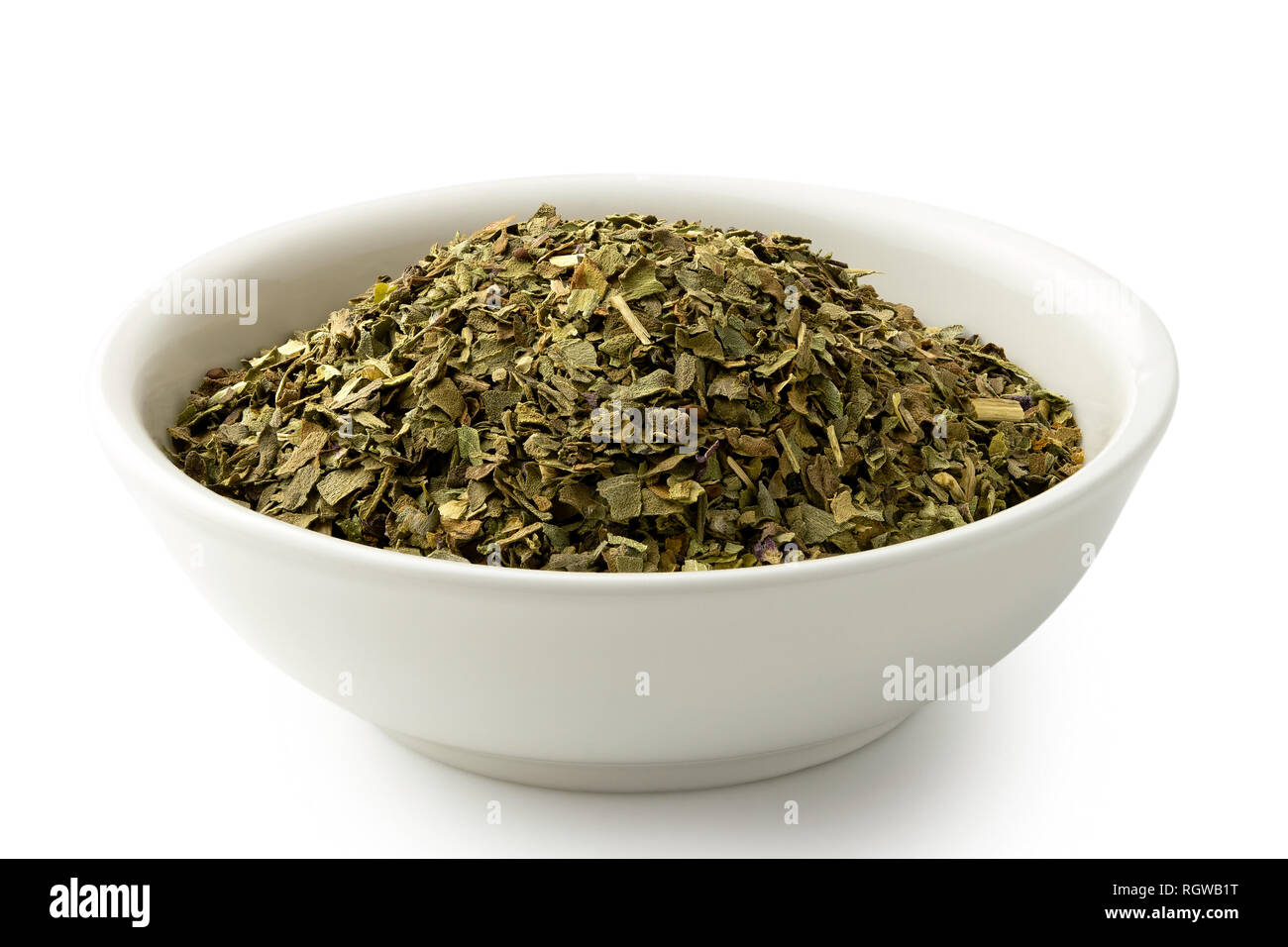 Dried chopped basil in white ceramic bowl isolated on white Stock Photo ...