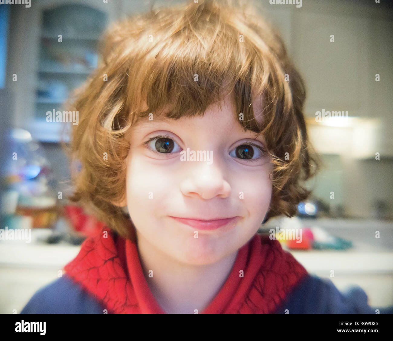 Child smiling and joking in a living room Stock Photo - Alamy