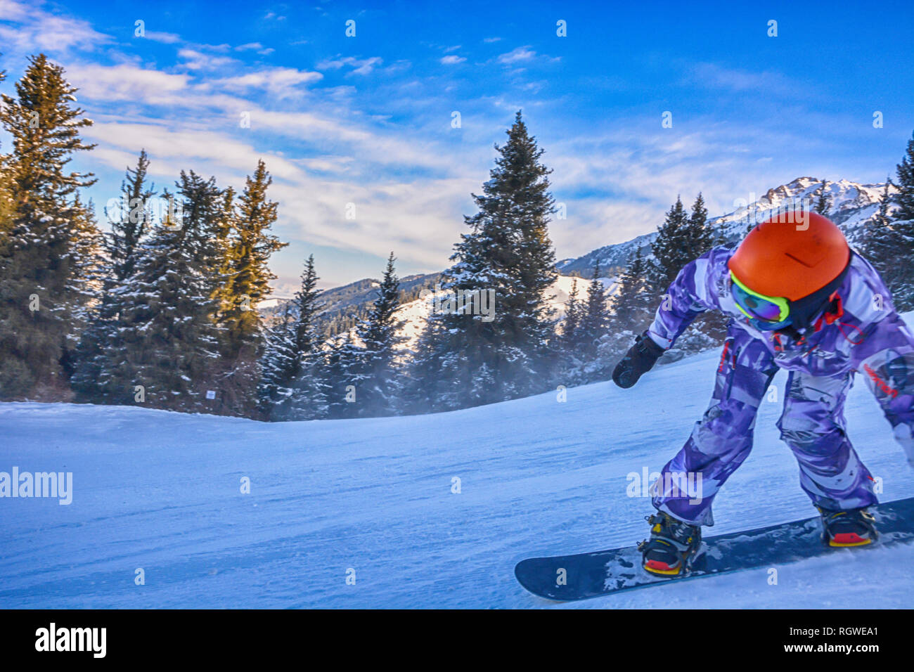 Young man snowboarding down snow hi-res stock photography and images ...