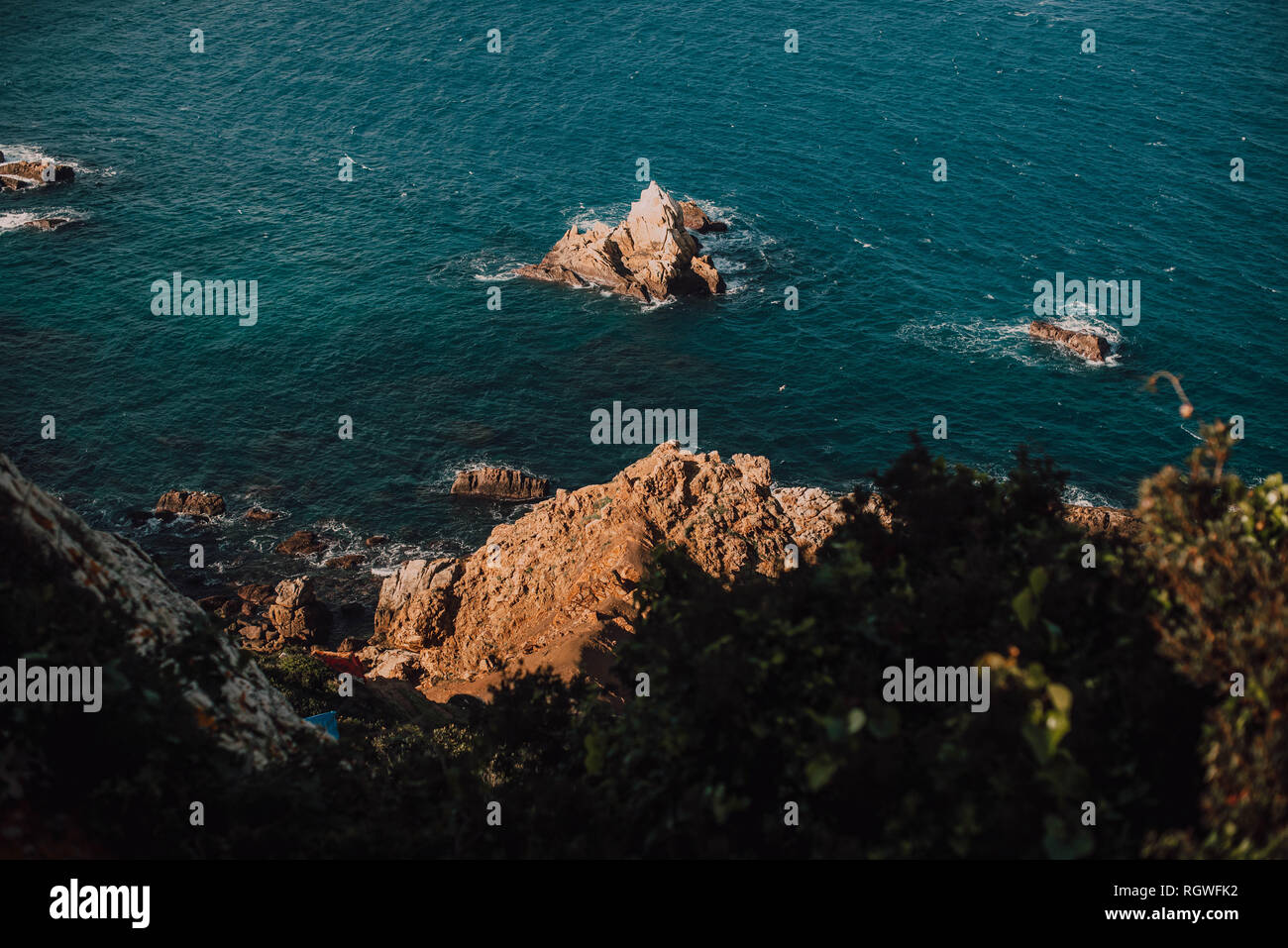Stone shore near blue water Stock Photo - Alamy