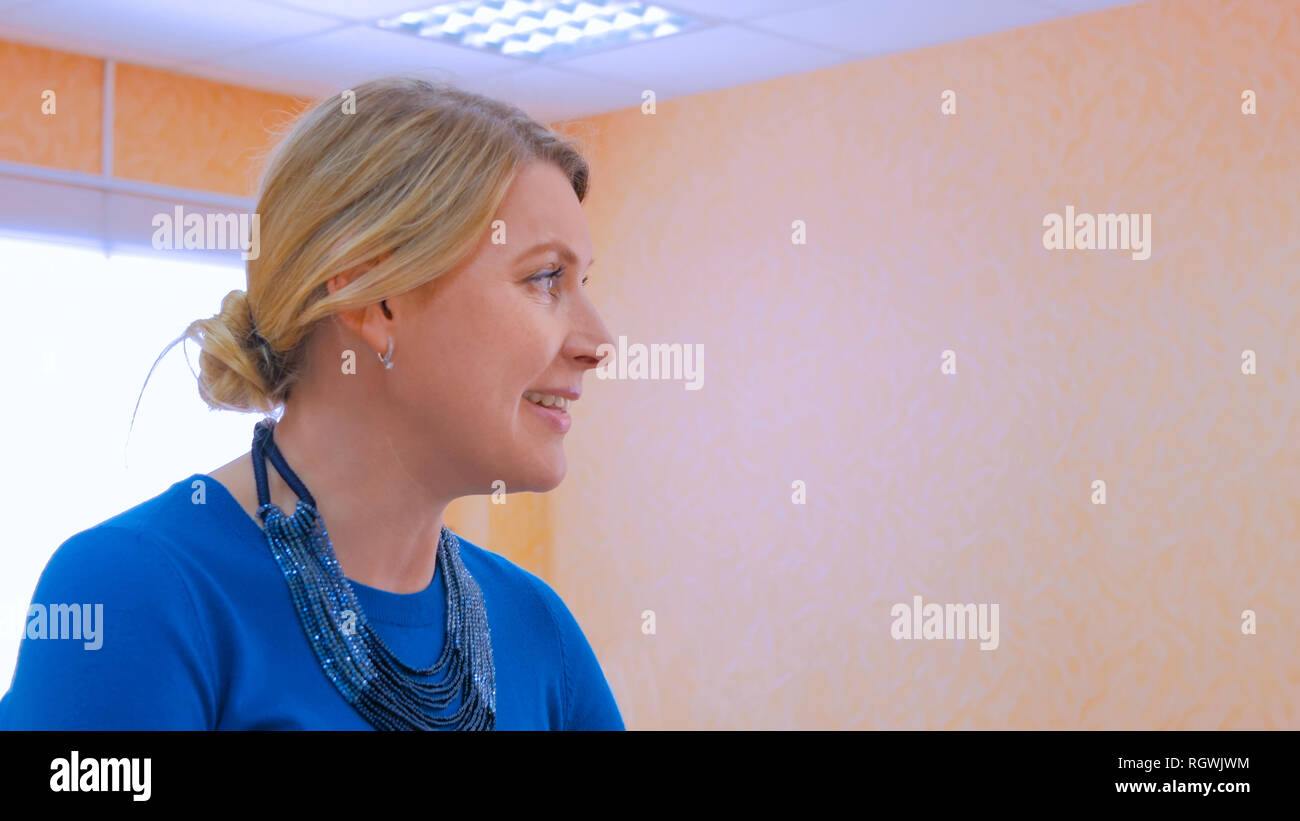 Portrait of professional woman designer, tailor talking with colleague ...