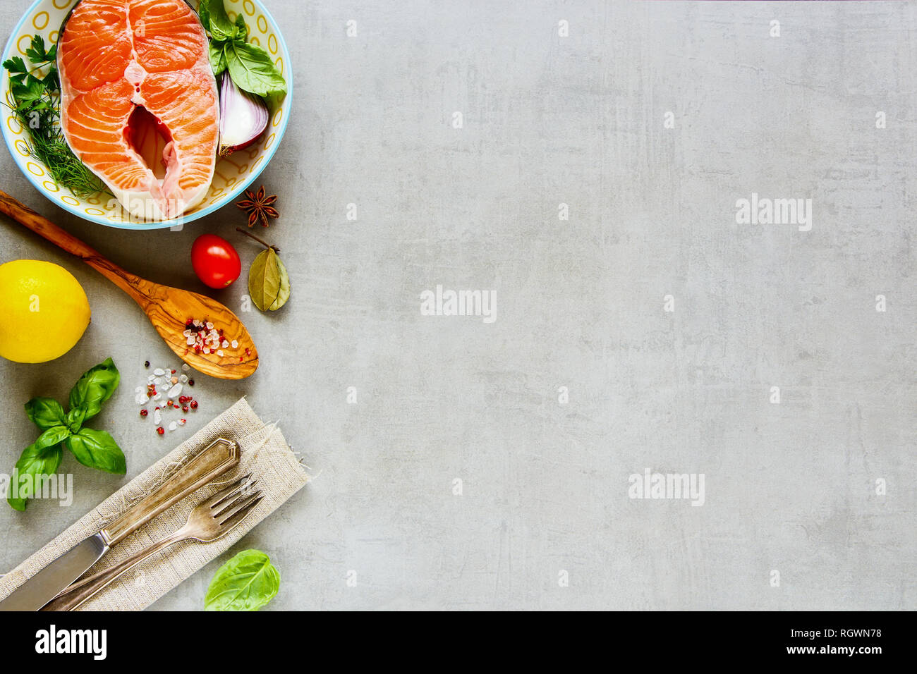 Fresh raw salmon steak and ingredients for cooking flat lay. Top view ...