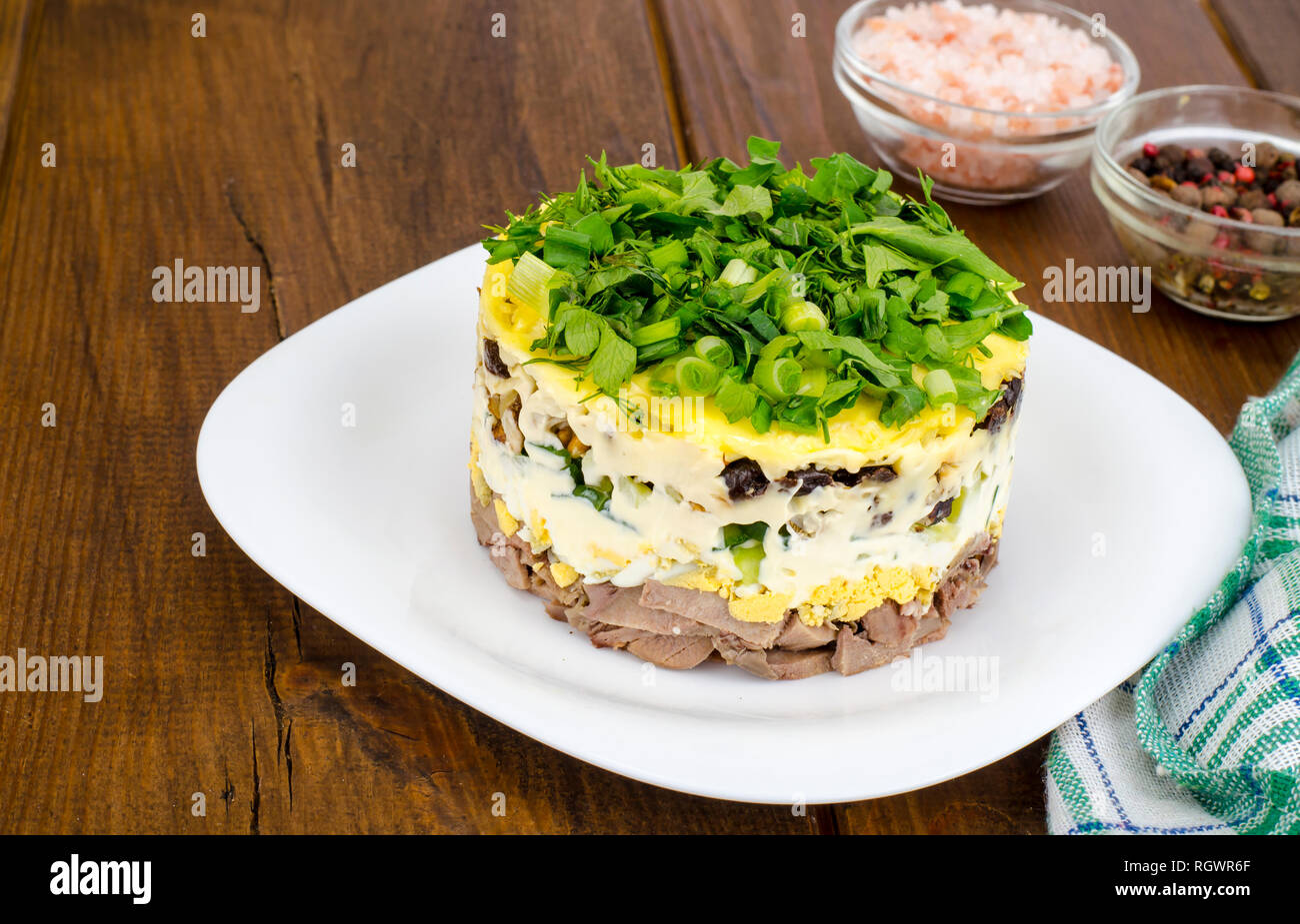 Layered portion salad with meat, cucumber, egg and mayonnaise. Studio ...