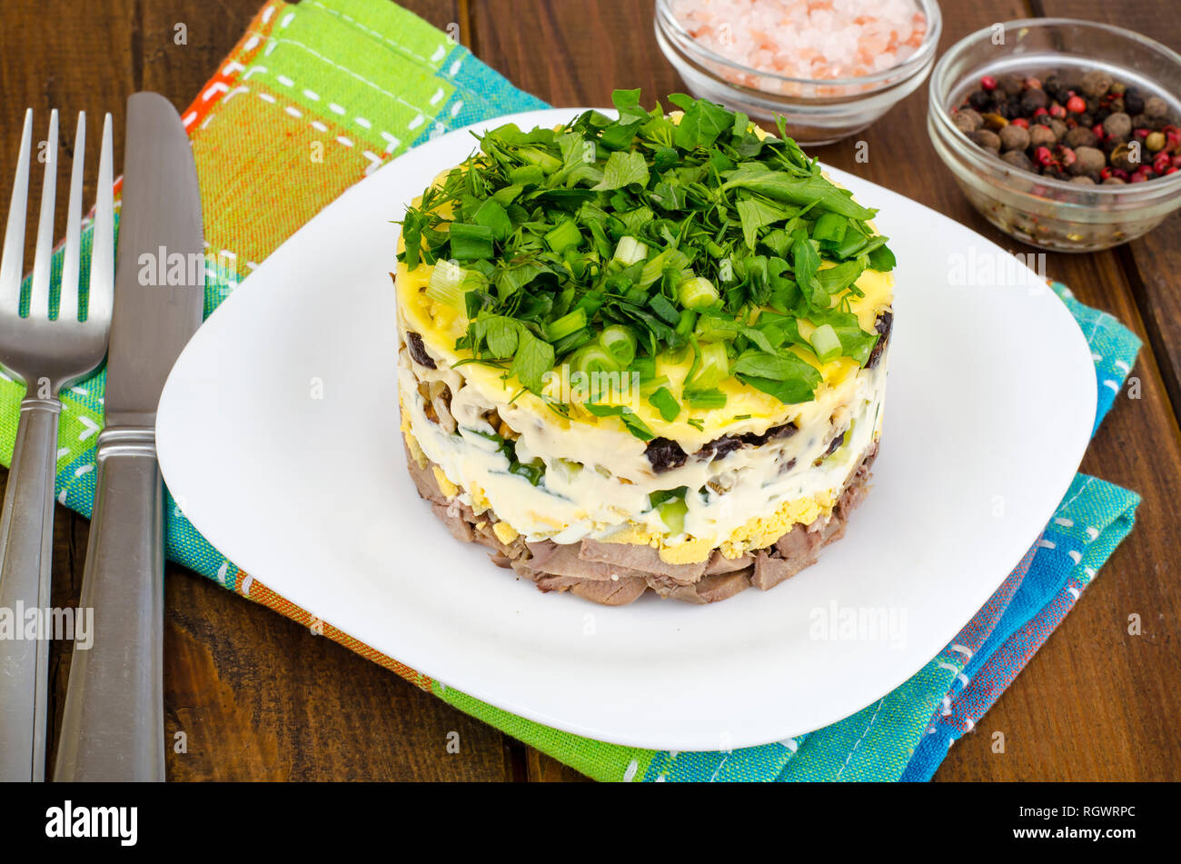 Layered portion salad with meat, cucumber, egg and mayonnaise. Studio ...