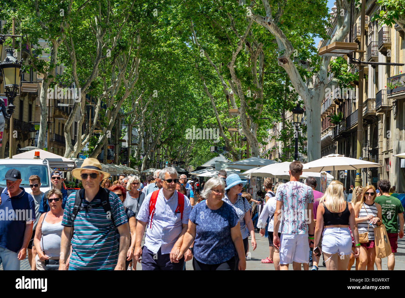 Tourists and Spaniards crowd the popular La Rambla area, Barcelona ...
