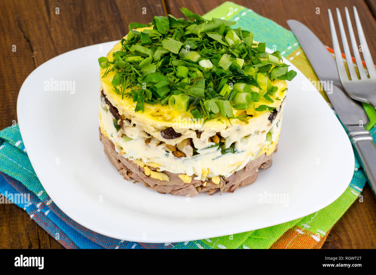 Layered portion salad with meat, cucumber, egg and mayonnaise. Studio ...