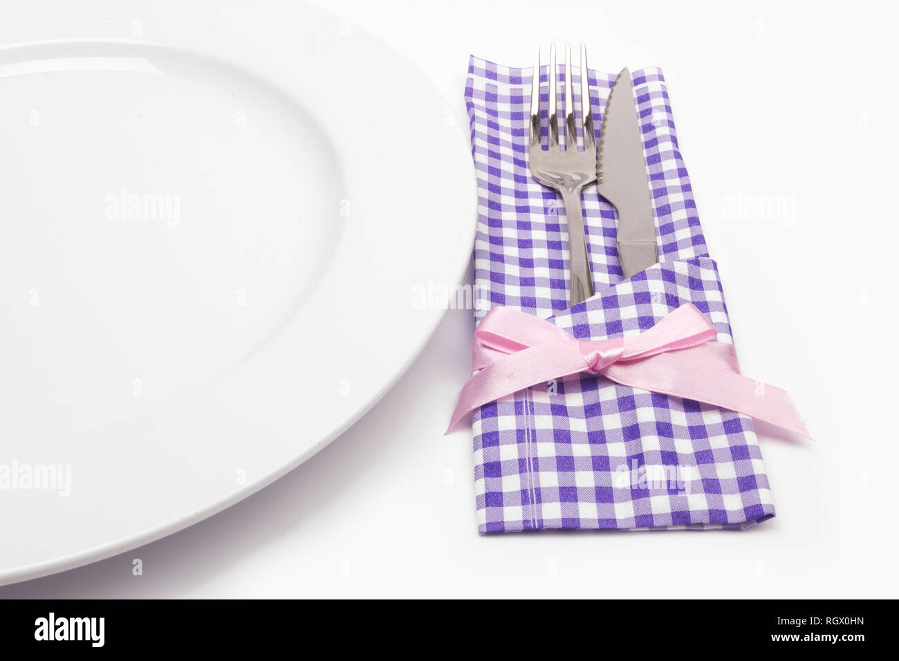 Table setting folded napkin on white background Stock Photo - Alamy