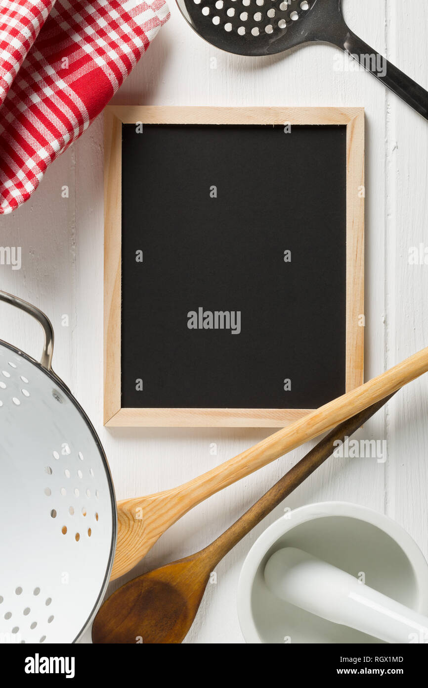 Blank, empty, black chalkboard with cooking utensils and red checkered ...