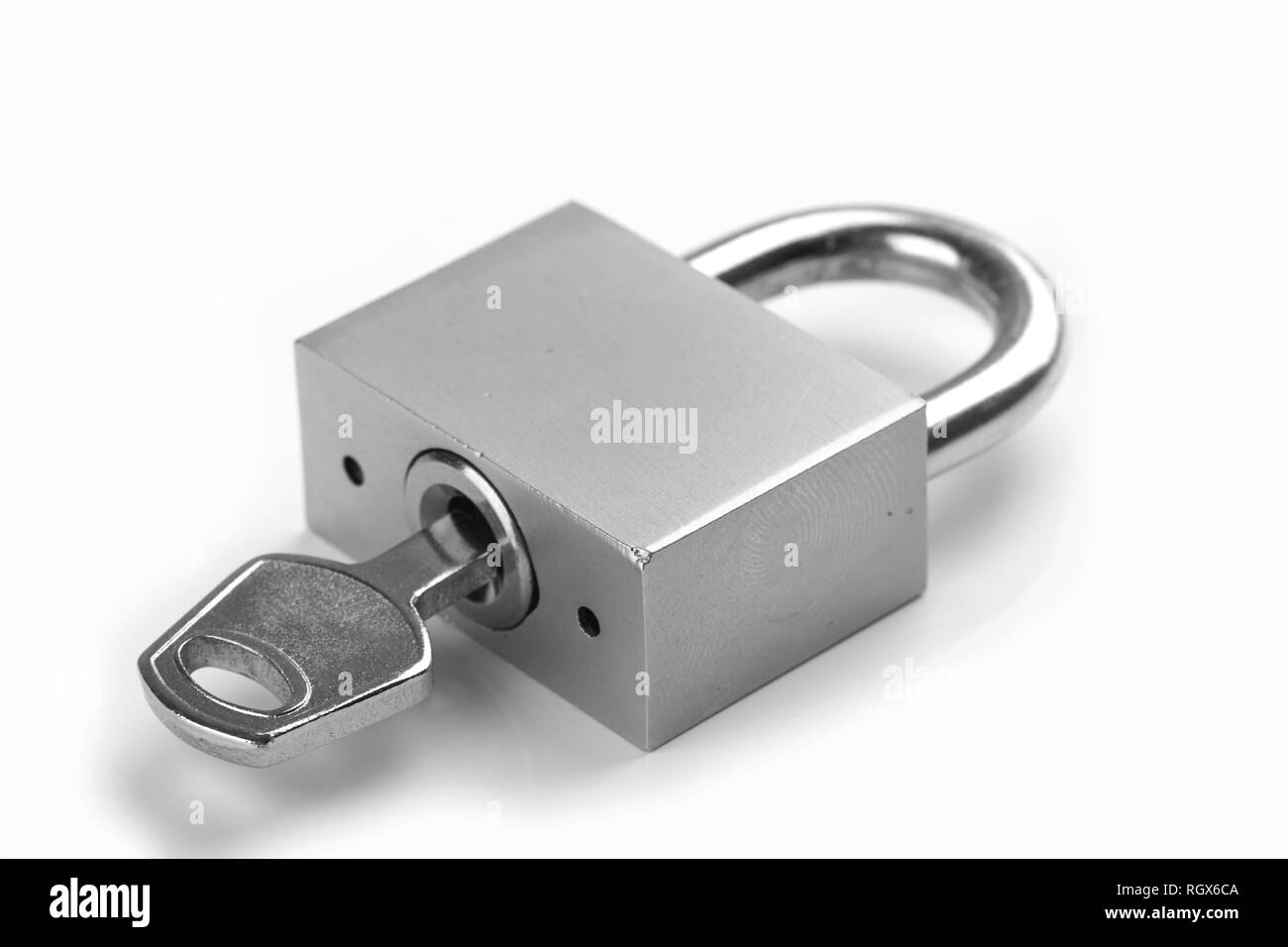 Padlock with key isolated on a white background Stock Photo - Alamy