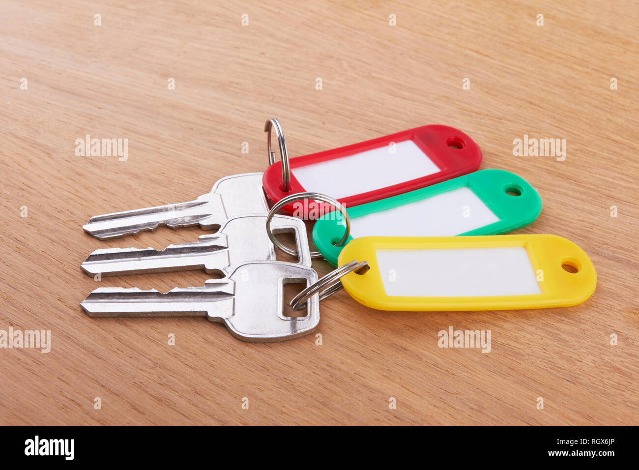 Three keys on a wooden background Stock Photo - Alamy