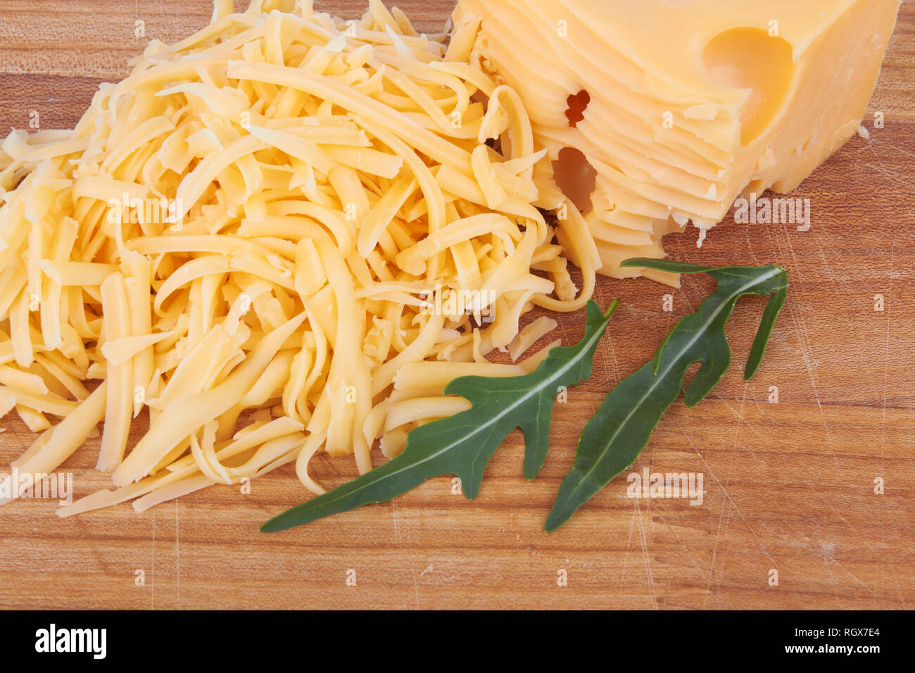 piece of cheese on board isolated on a white background Stock Photo - Alamy