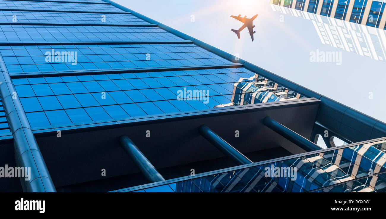 Bottom angle view of airplane in sky over city buildings Stock Photo ...