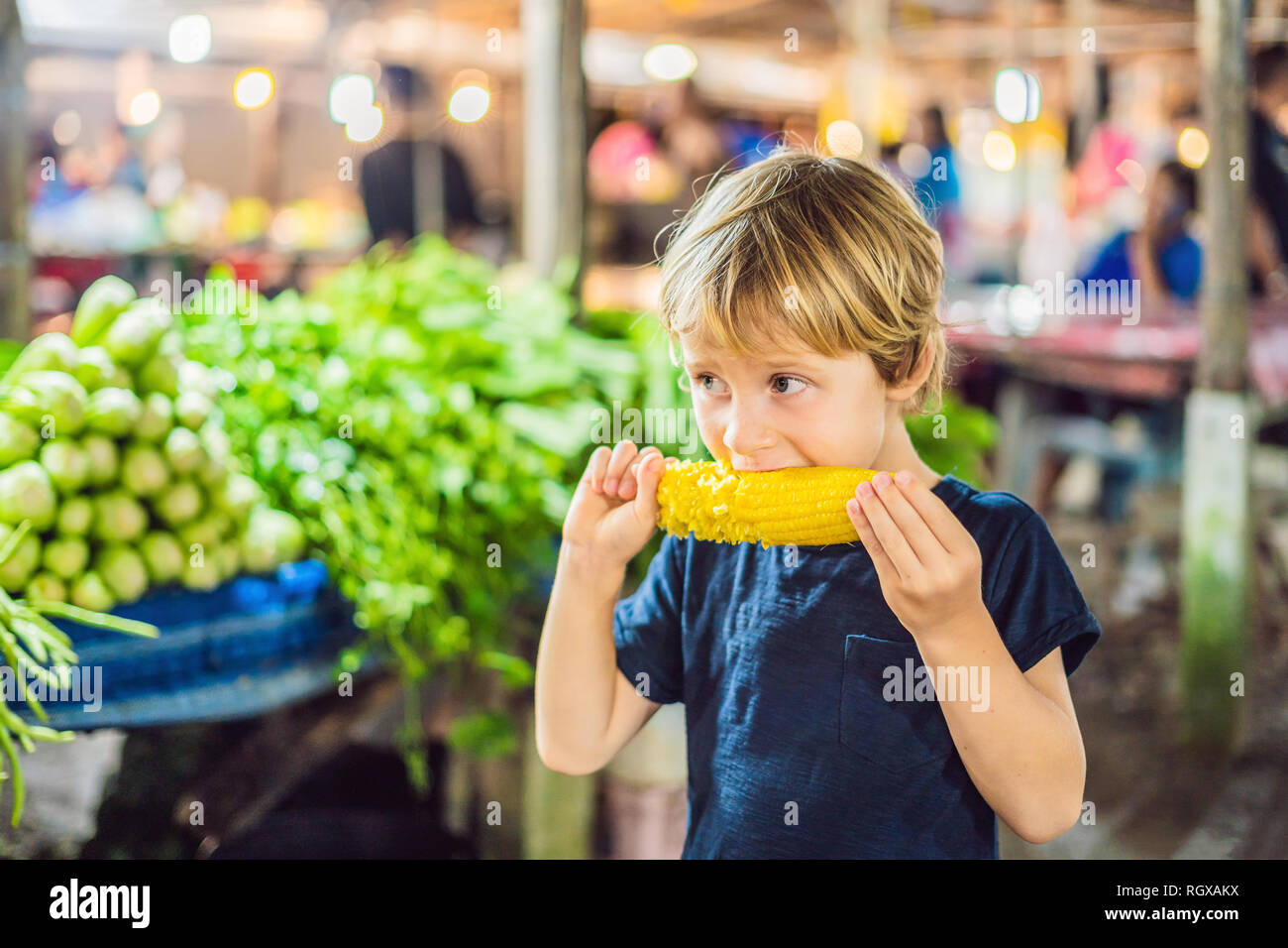 Boy tourist on Walking street Asian food market Stock Photo - Alamy
