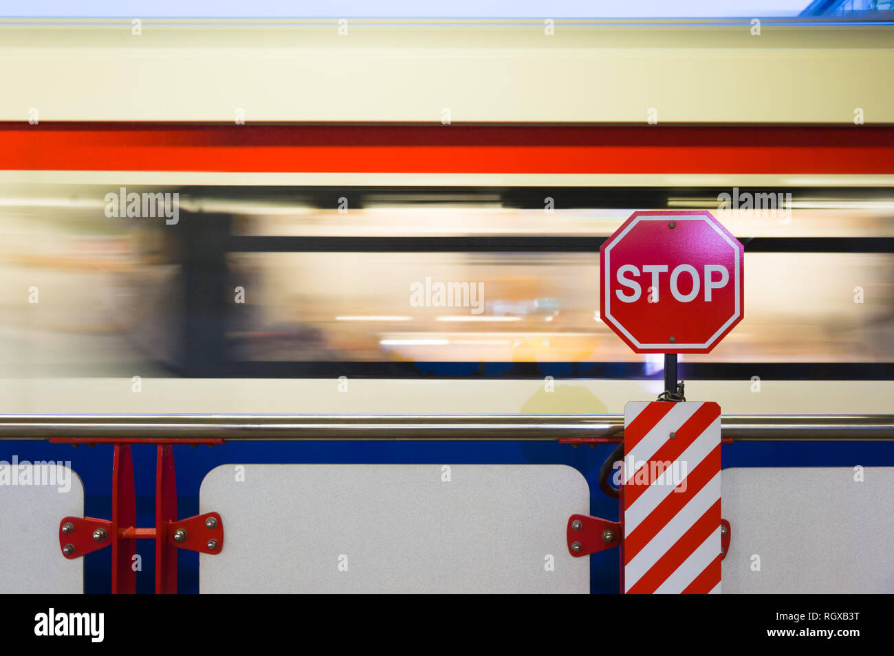 Stop sign board with moving train on background Stock Photo - Alamy