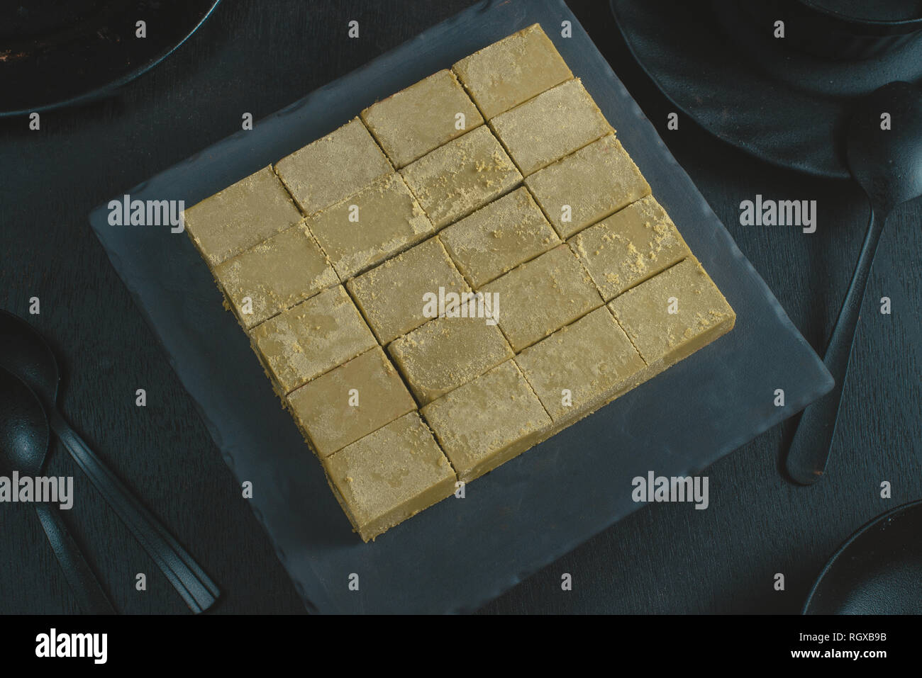 Green tea soft chocolates on a black background with copy space. Matcha ...