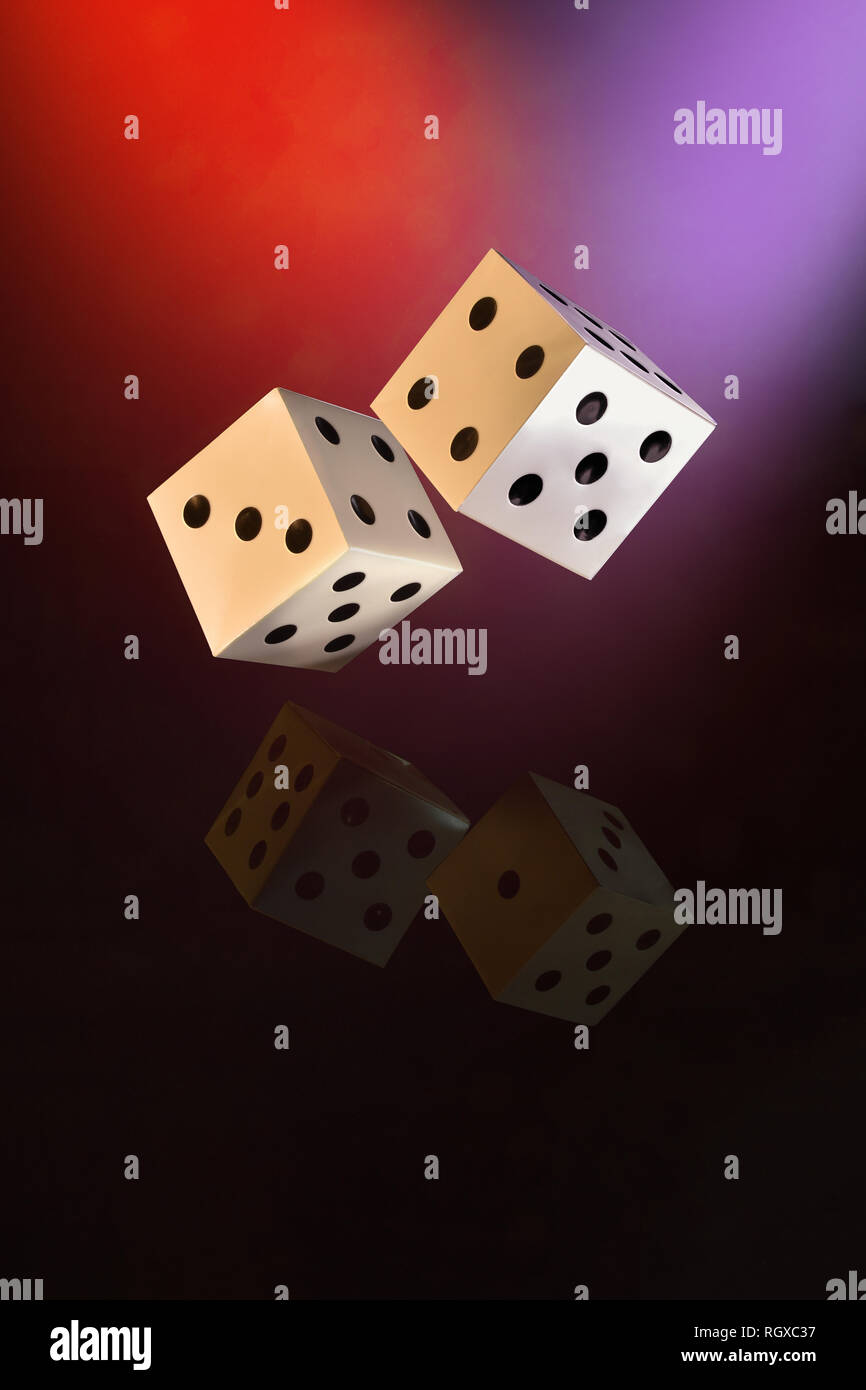 Falling dice with reflection on dark background Stock Photo - Alamy