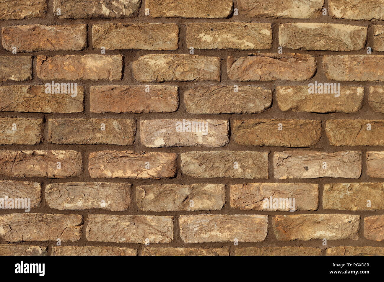 wall of brown brick hand-molded texture background Stock Photo - Alamy