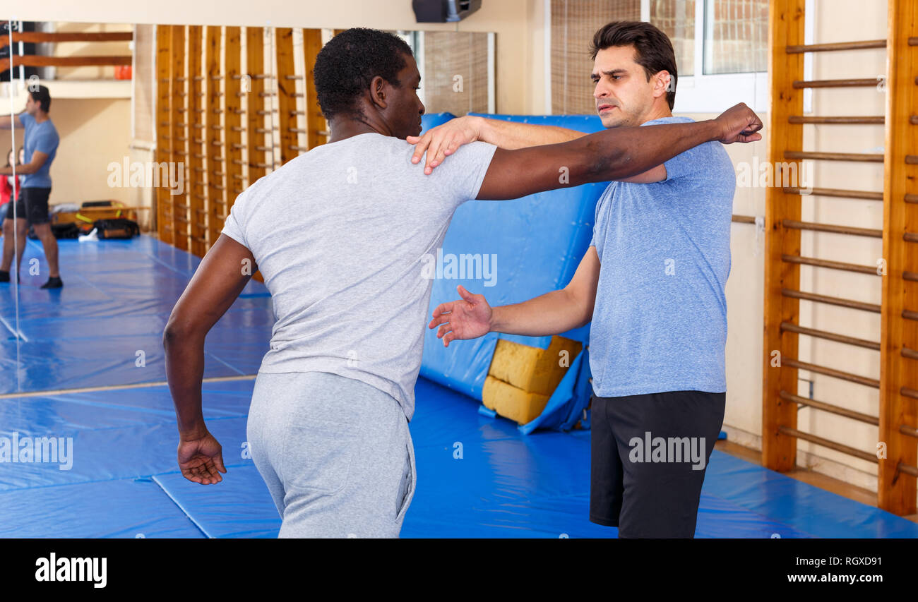 Males training attack movements in pair at self protection workout ...