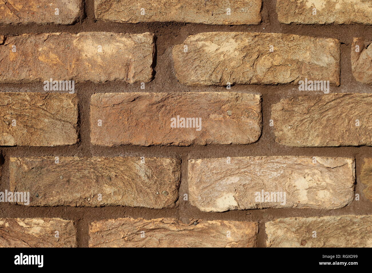 wall of brown brick hand-molded texture background Stock Photo - Alamy