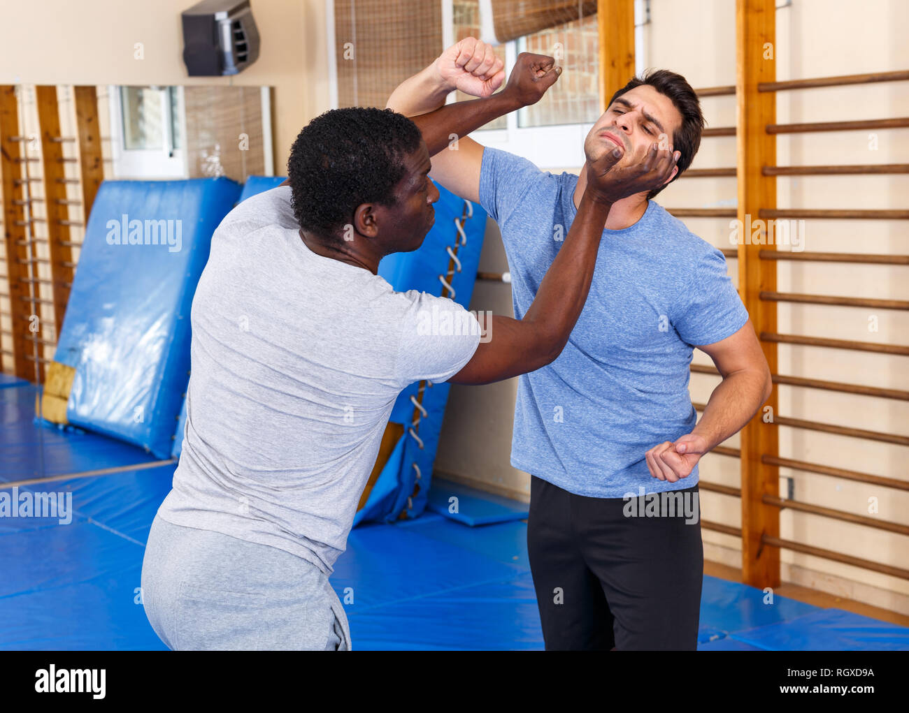 Men practicing effective techniques of self-defence during individual ...