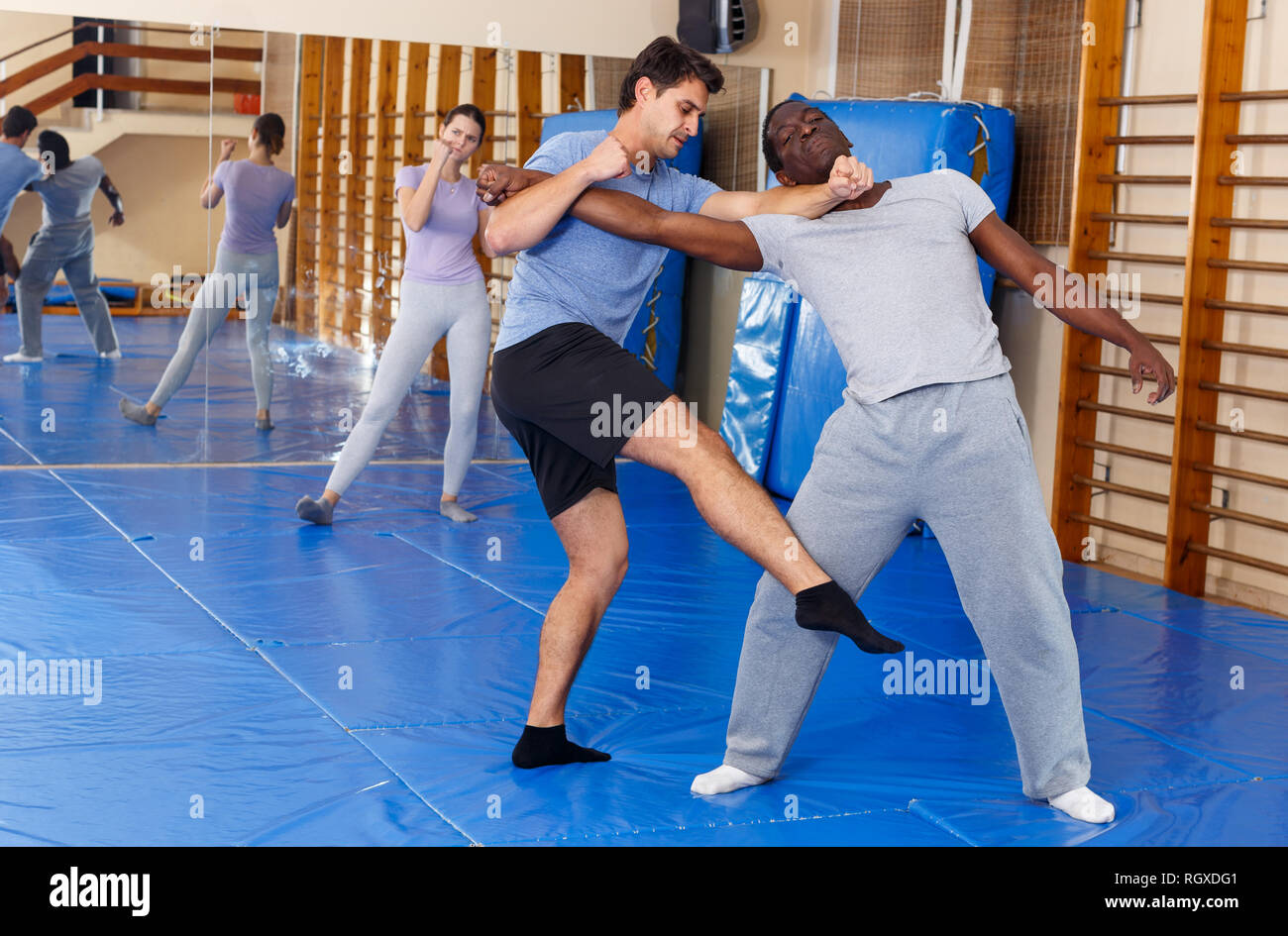 Men practicing effective techniques of self-defence during individual ...