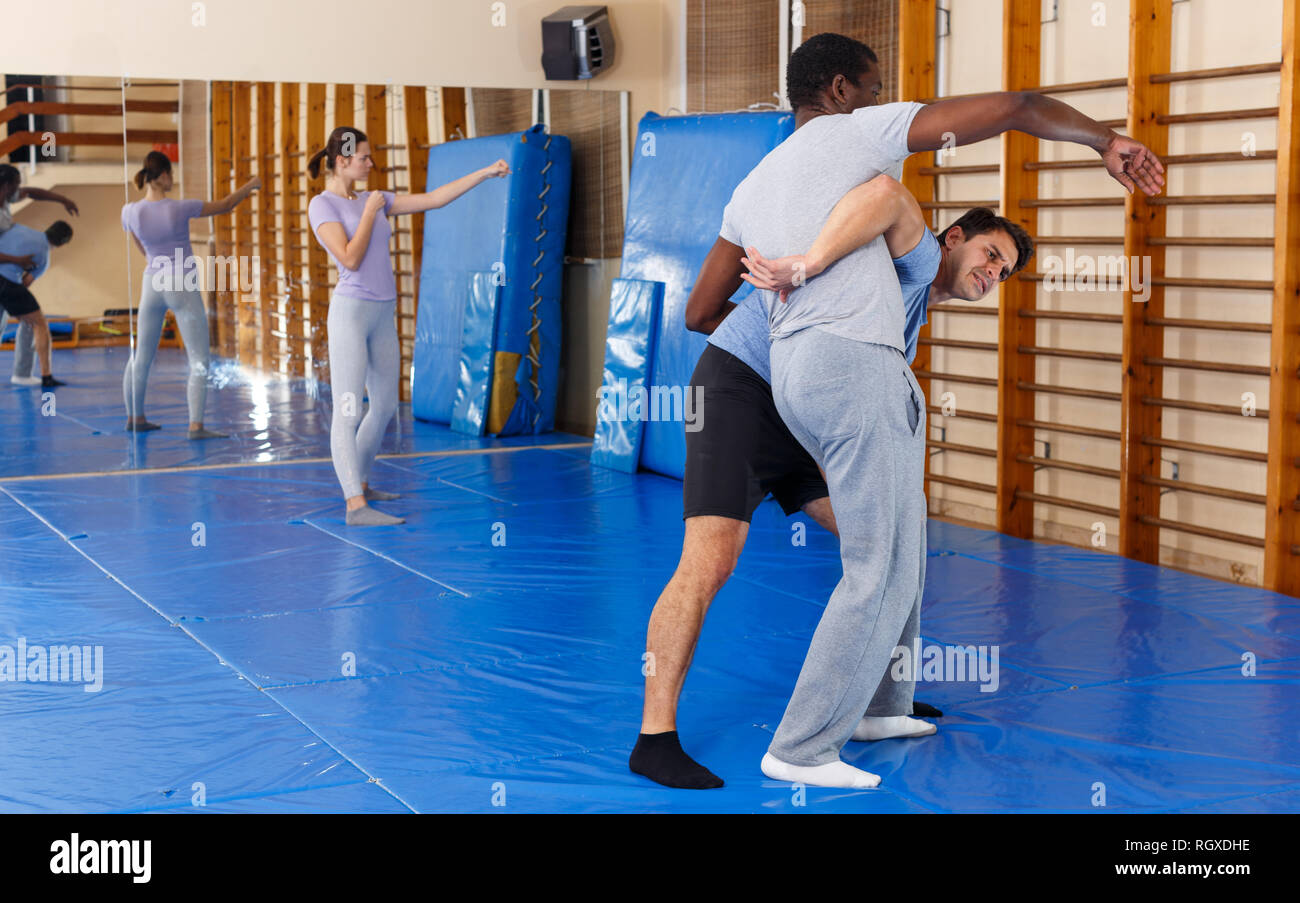 Males training attack movements in pair at self protection workout ...