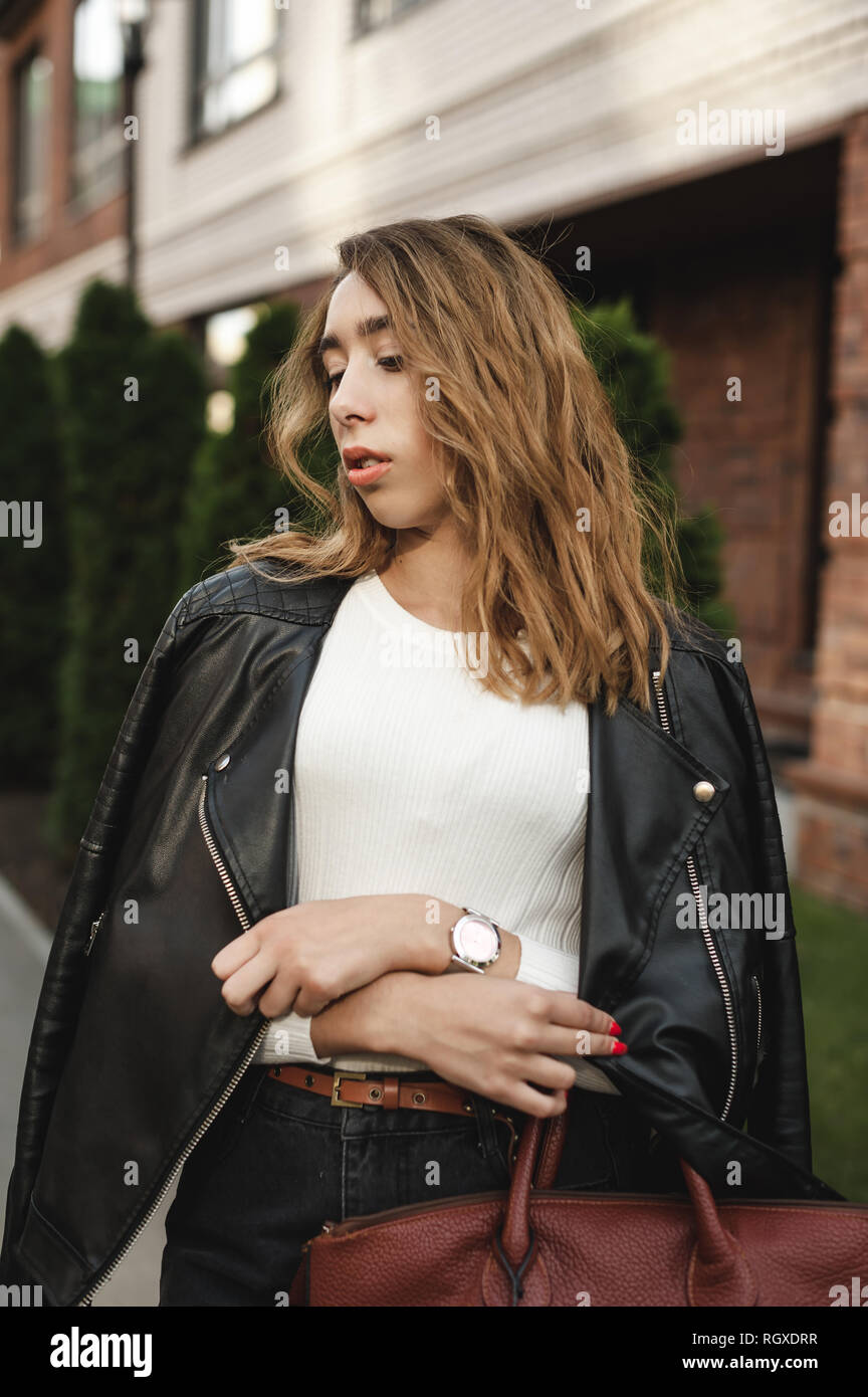 portrait of a young beautiful woman on street, model posing, women's ...