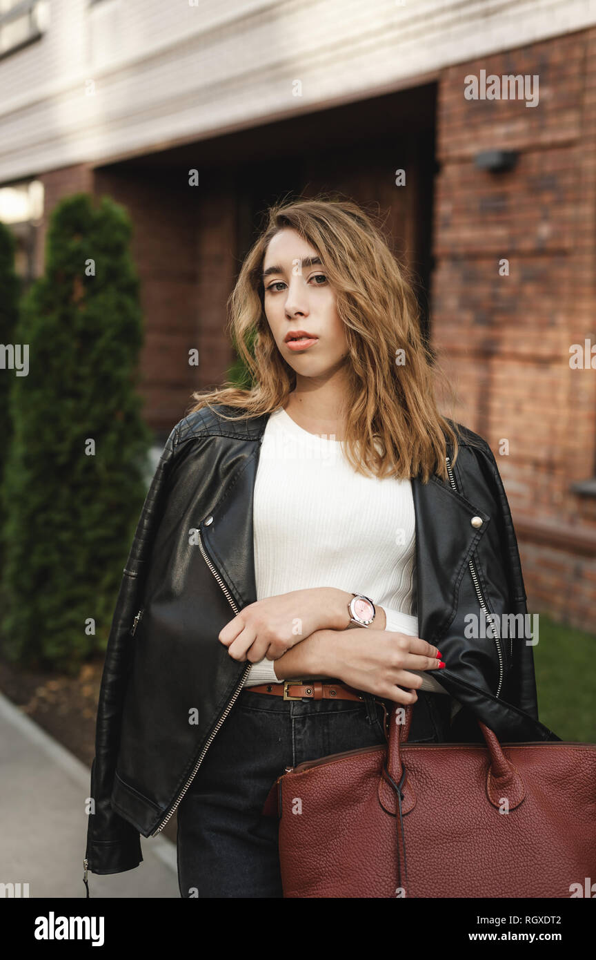 portrait of a young beautiful woman on street, model posing, women's ...