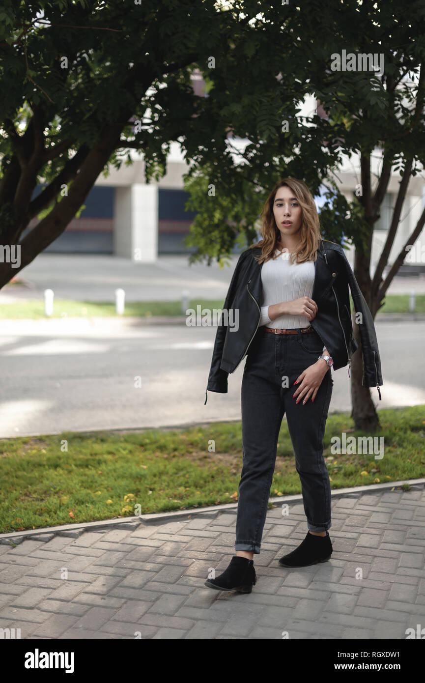 portrait of a young beautiful woman on street, model posing, women's ...