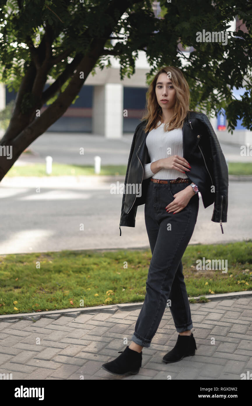 portrait of a young beautiful woman on street, model posing, women's ...