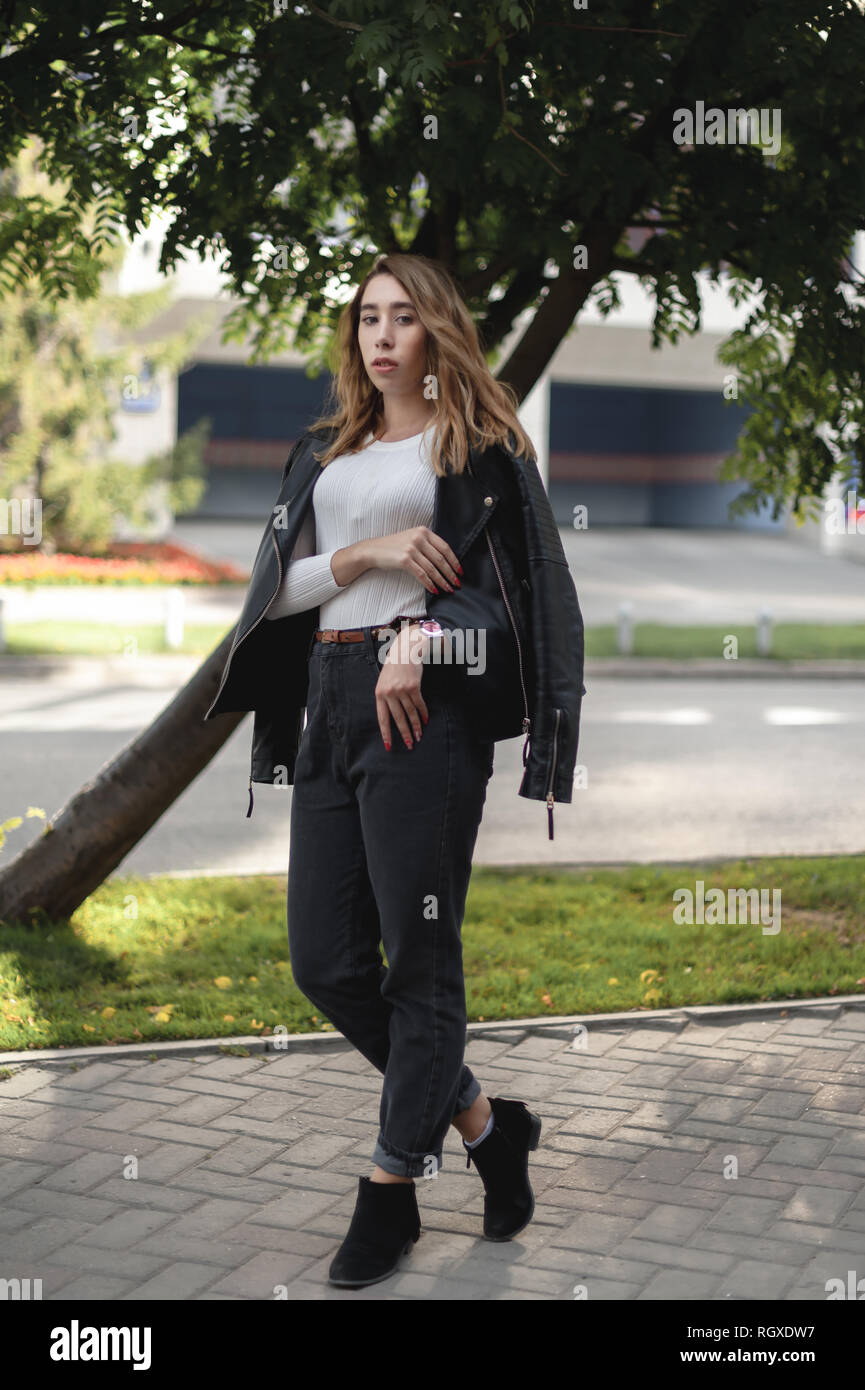 portrait of a young beautiful woman on street, model posing, women's ...