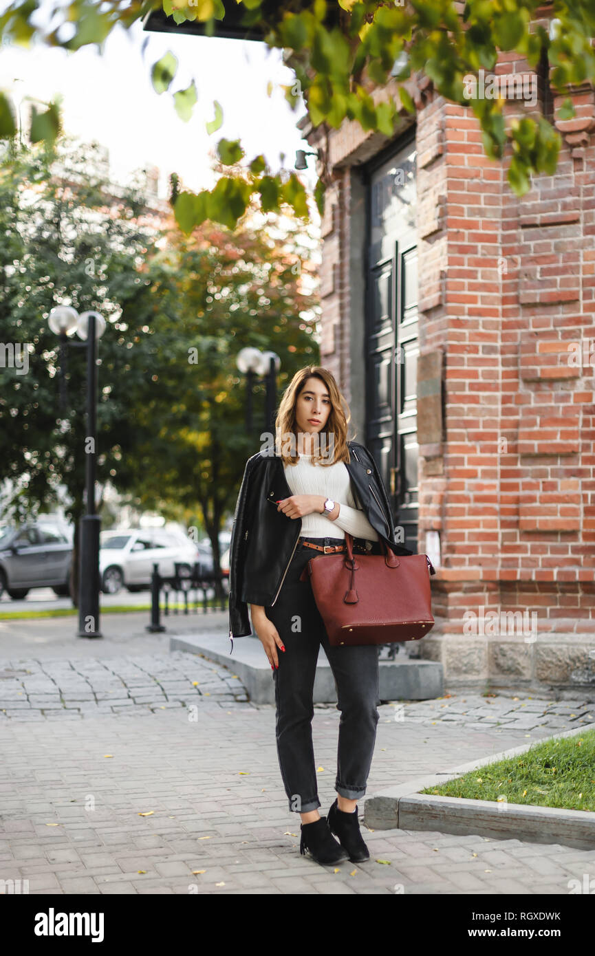 portrait of a young beautiful woman on street, model posing, women's ...