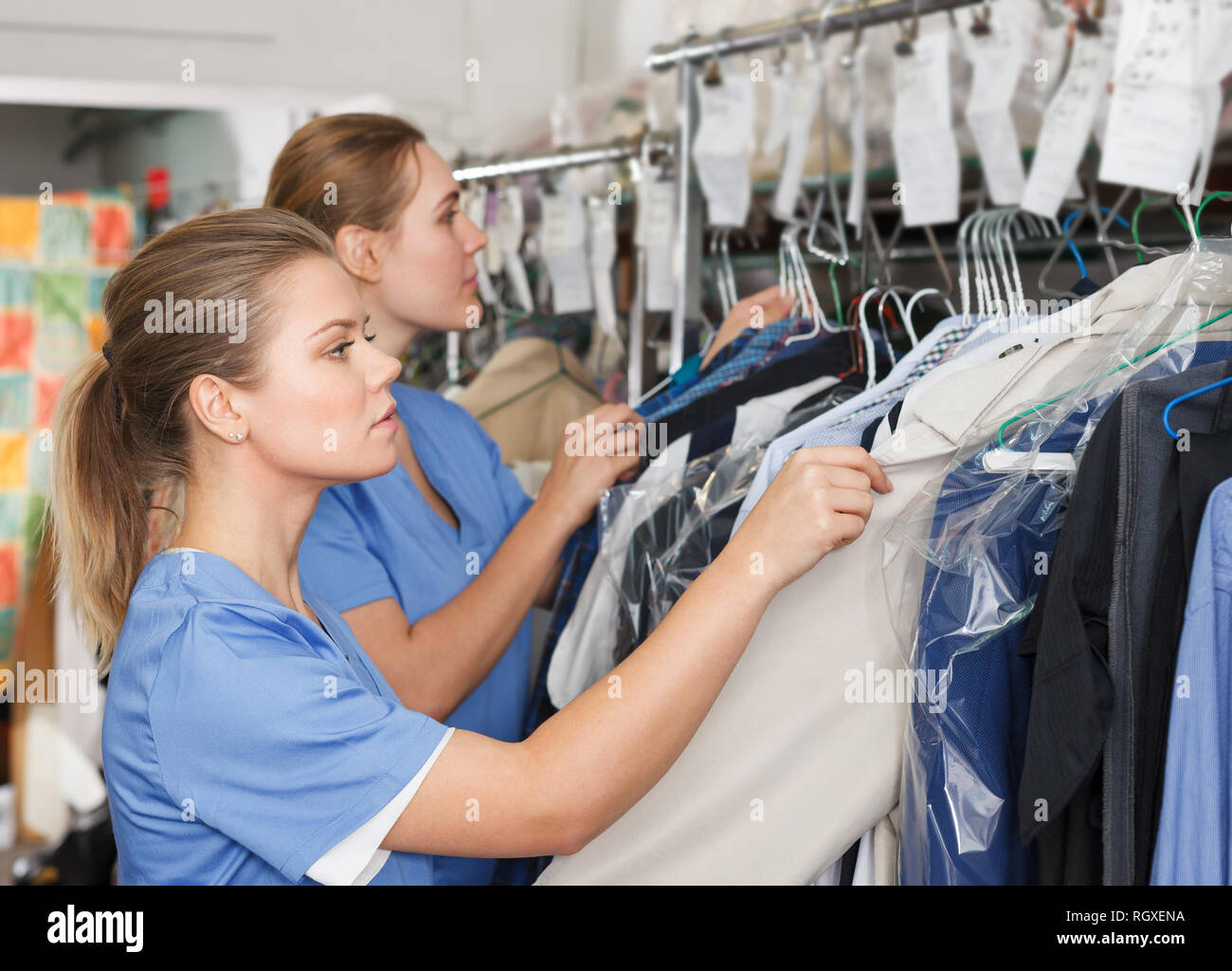 Two pretty female colleagues workers of laundry during daily work Stock ...