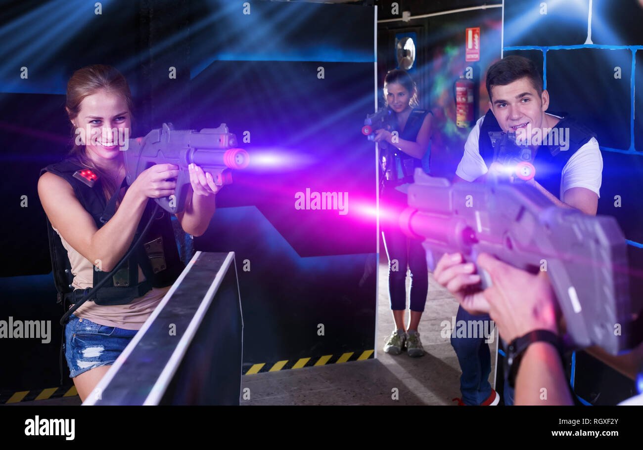 team of players aiming from laser pistols to an opponentplaying laser ...