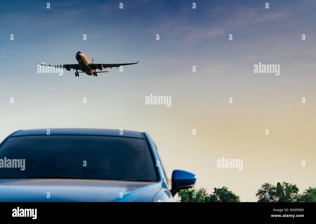 Commercial airline. Passenger plane landing approach blue SUV car at ...
