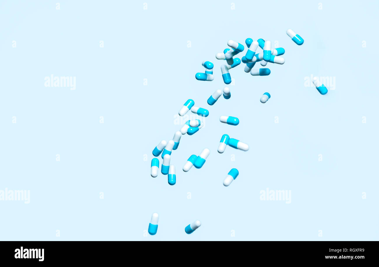 Blue-white capsule pill fall down. Antibiotic drug use with reasonable ...