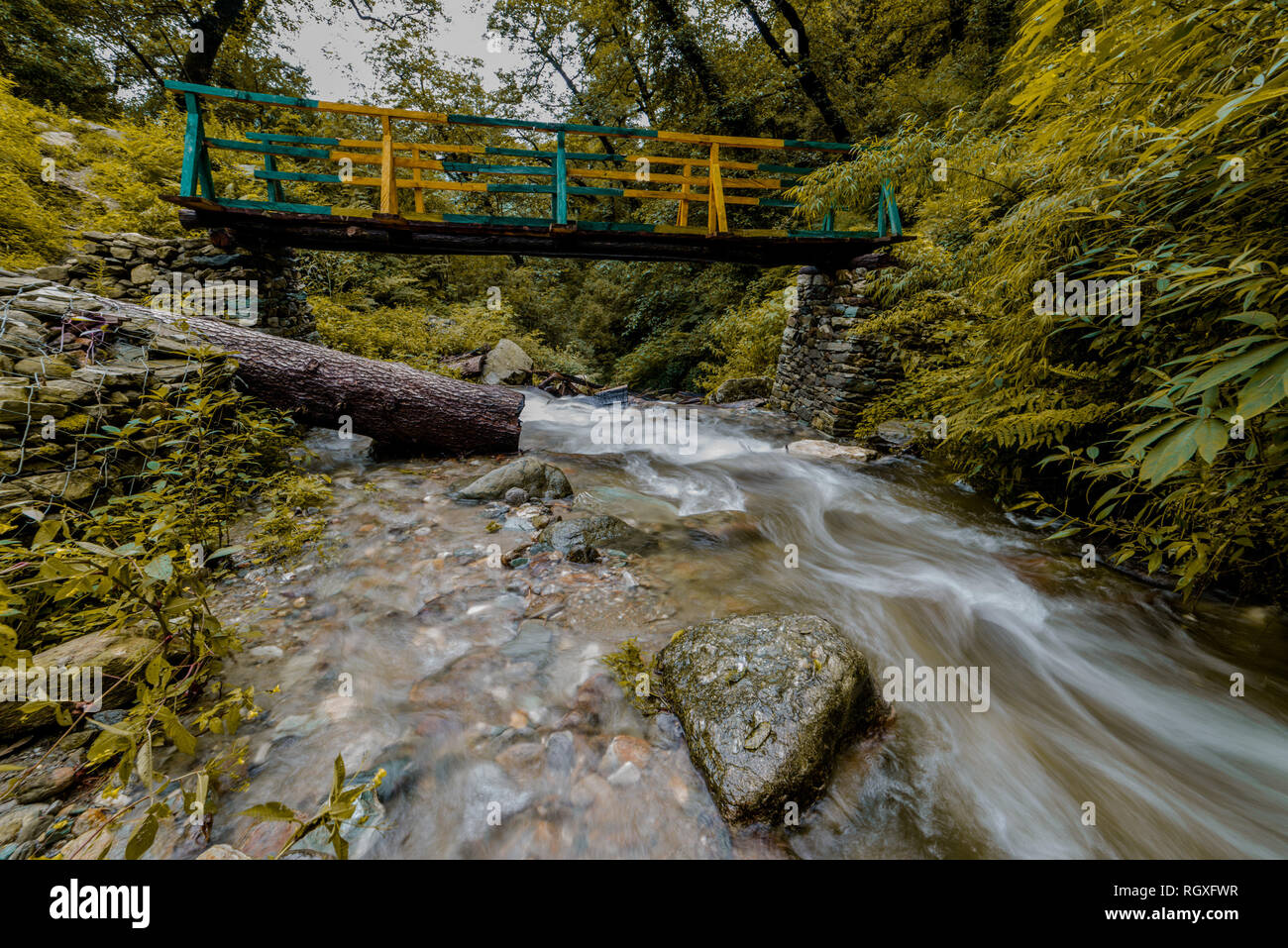 Photo of wooden bridge over waterfall in himalayas - sainj, kullu ...