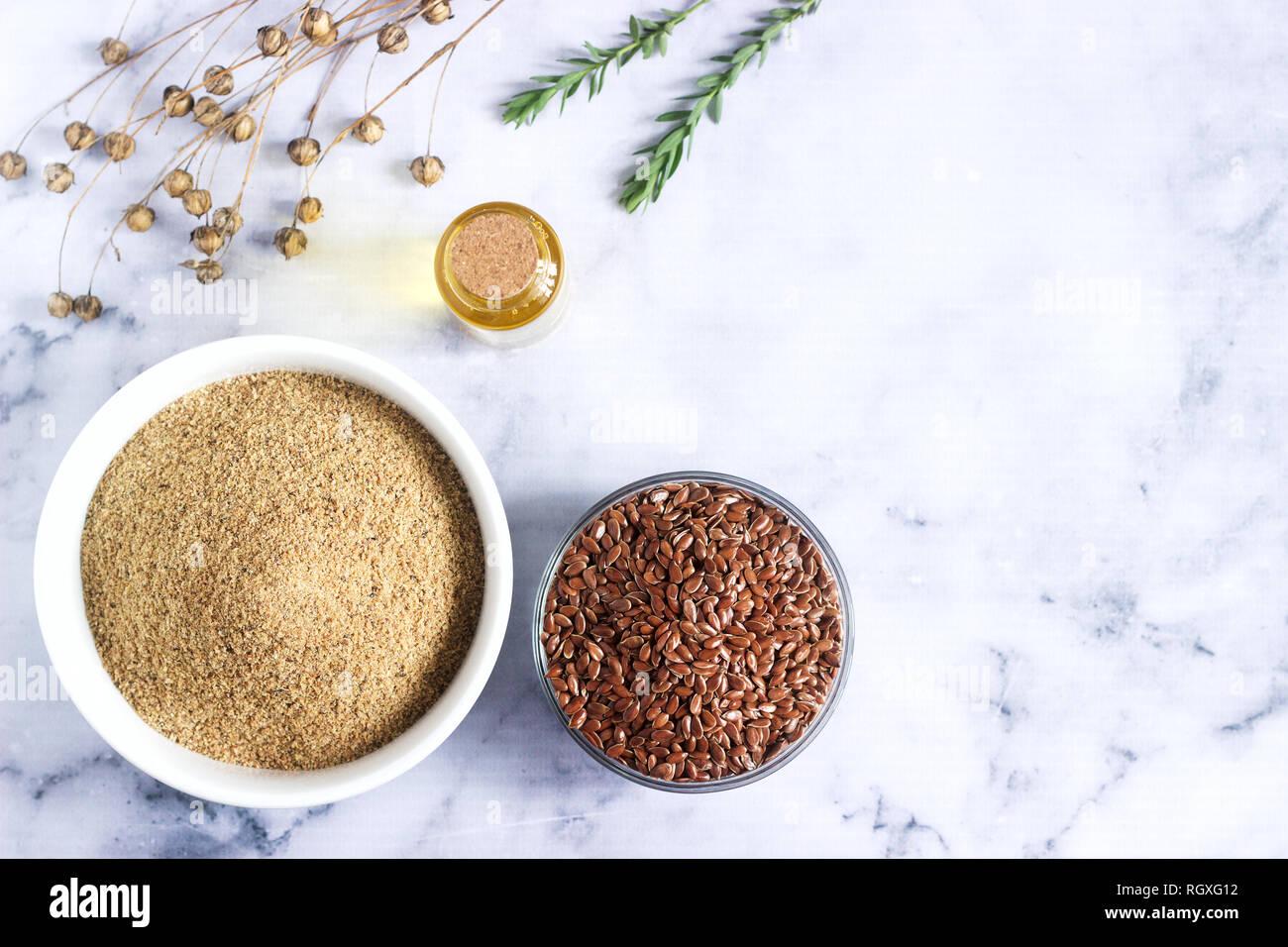 Flax seeds, flax flour, oil with sprouts and flax seed boxes on a light ...