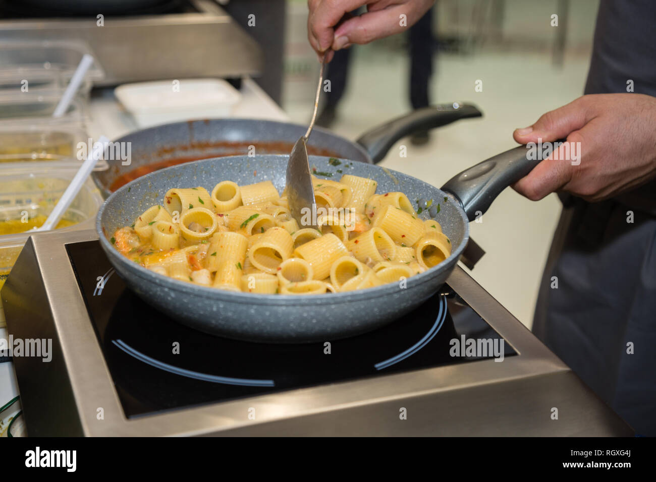 Cooking Italian Pasta inside Saucepan: Chef at Work in the Kitchen ...