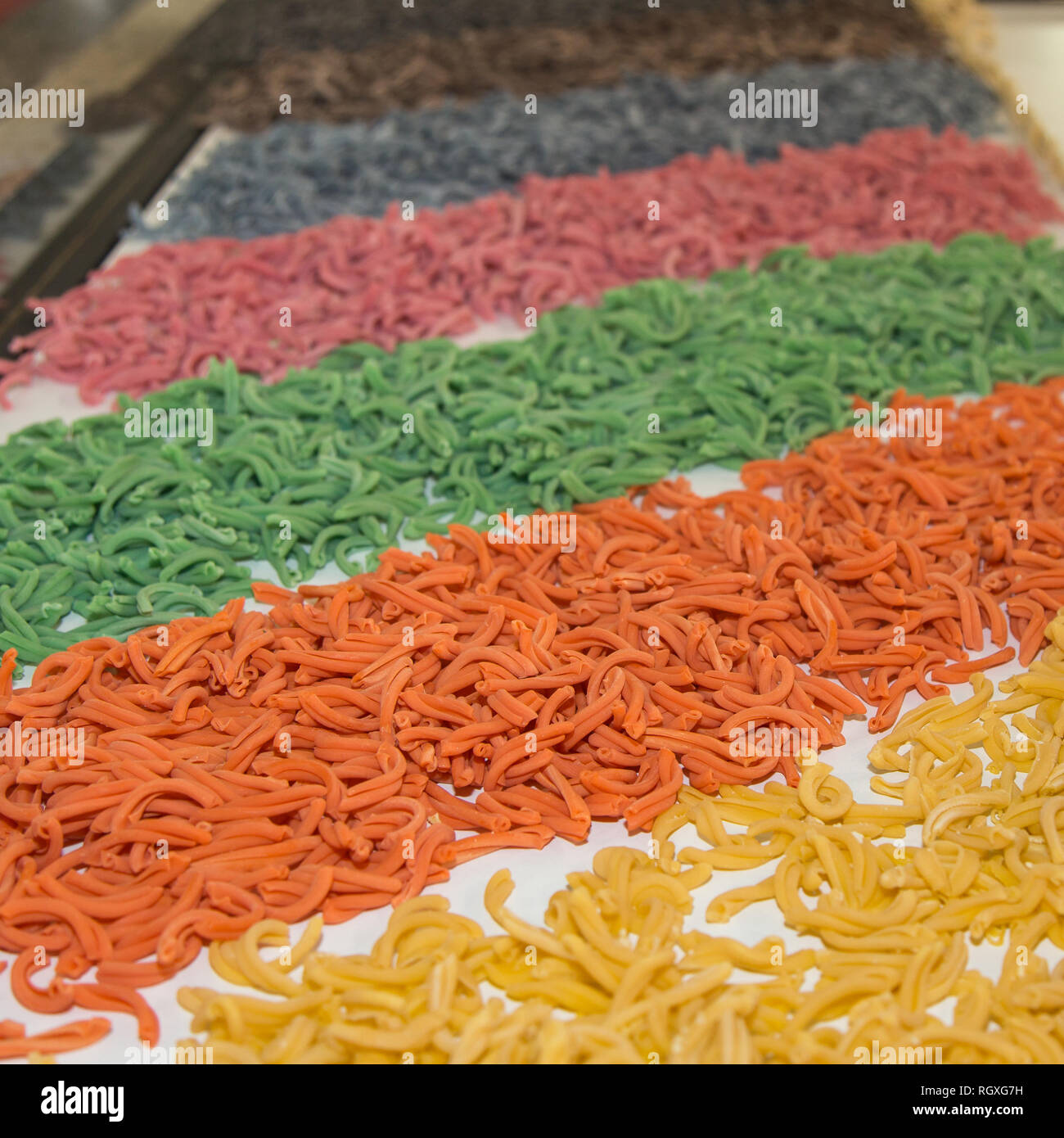 Display of a Food Store with Various Rows of Raw Coloured Pasta Stock ...