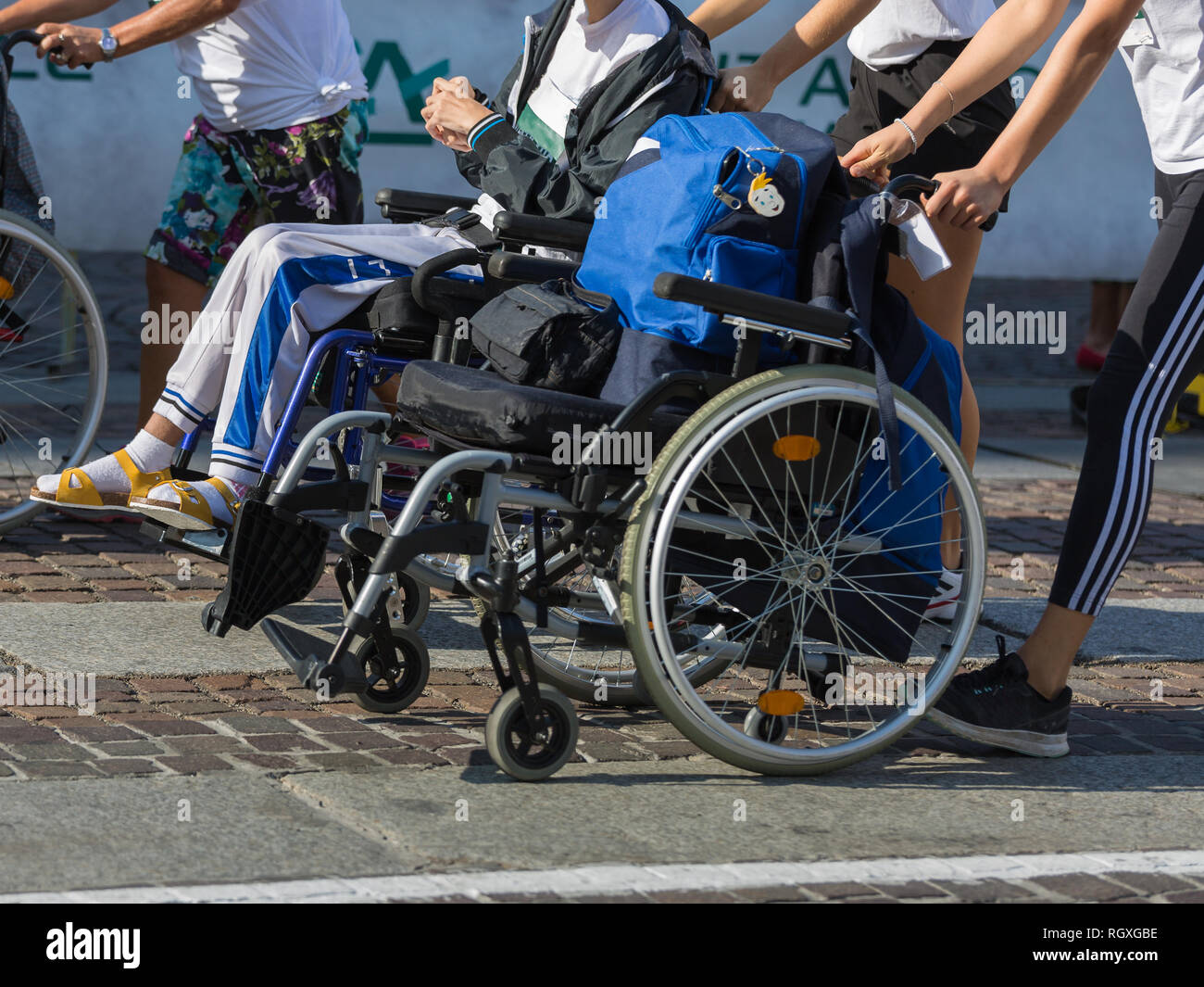 Disabled Athlete in a Sport Wheelchair during Marathon Helped by Female ...